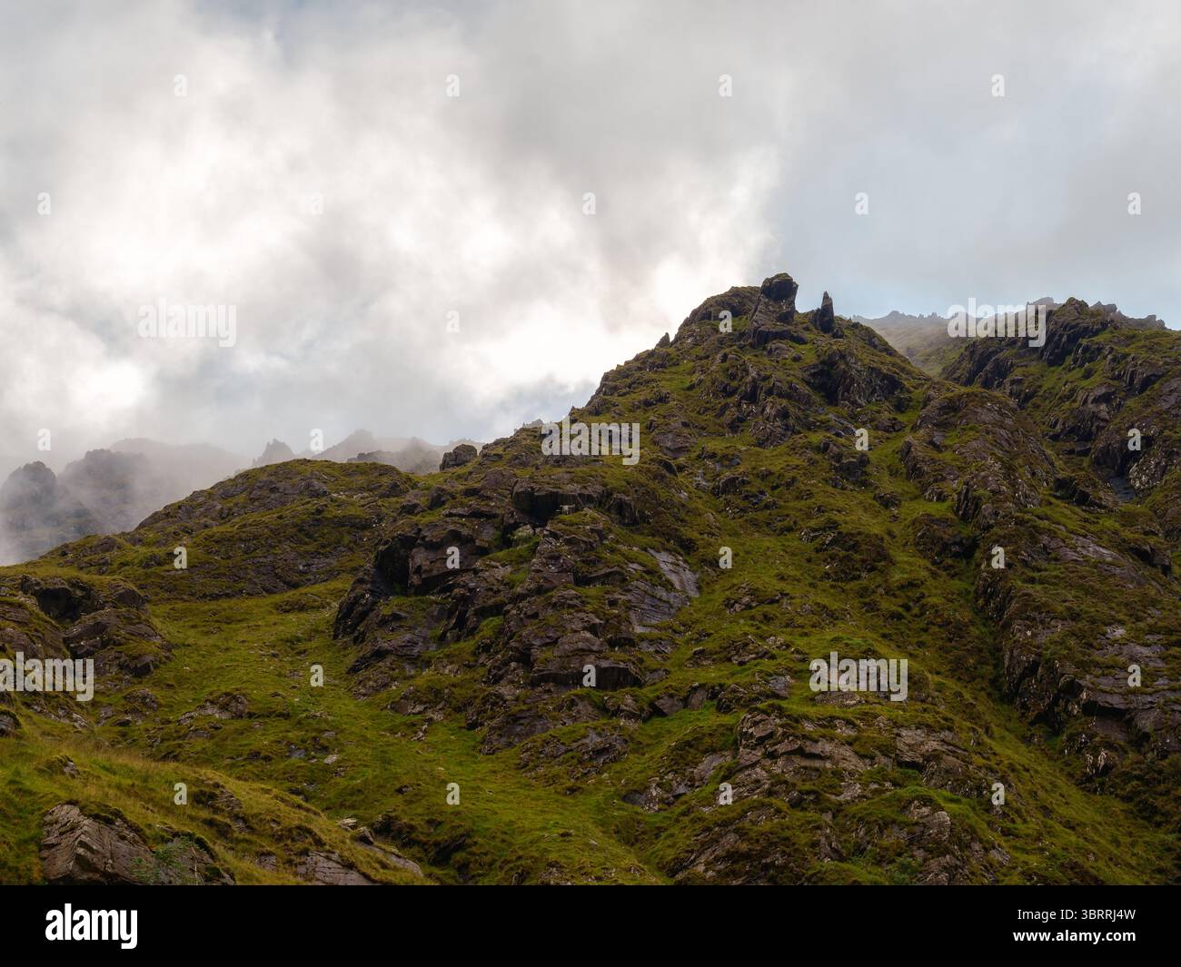 Viewing green landscape and rugged cliffs on the Carrauntoohill walkway ...