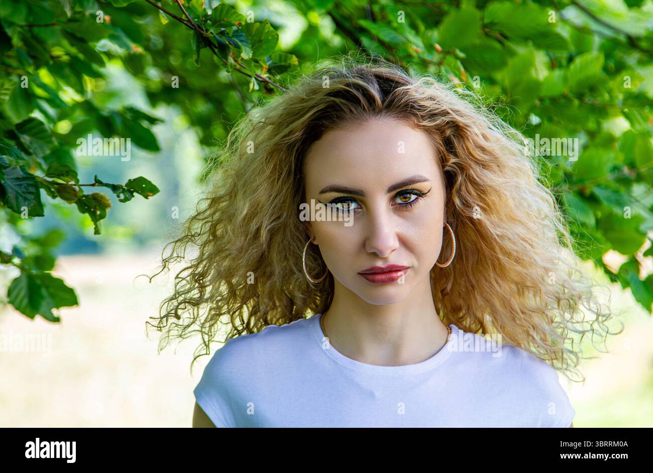 On a sunny summers day glamorous blonde Moldovan model posing under ...