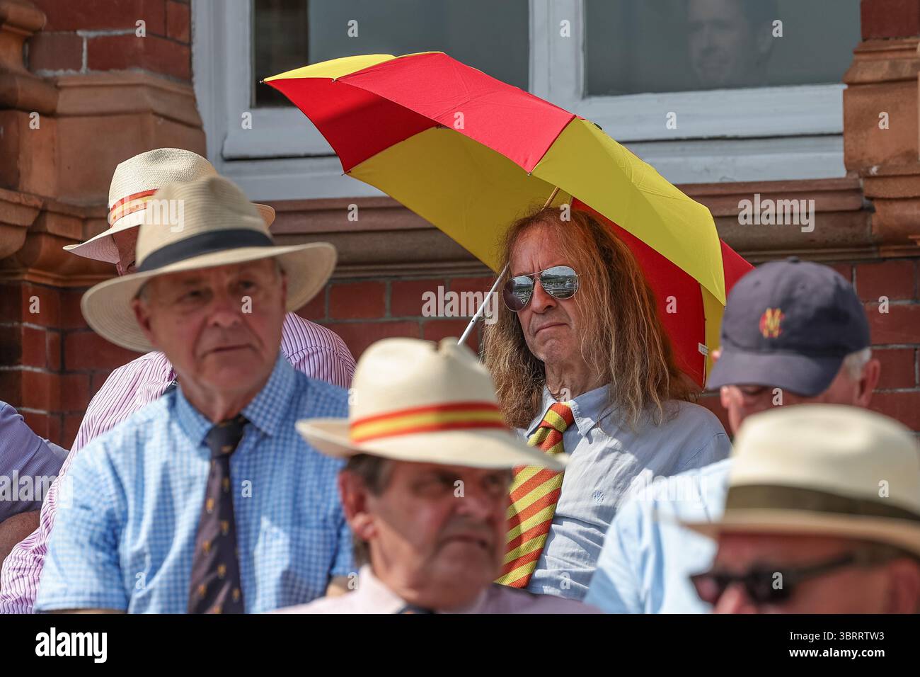 Marylebone Cricket Club members sit in the sun in the Lords Pavilion ...