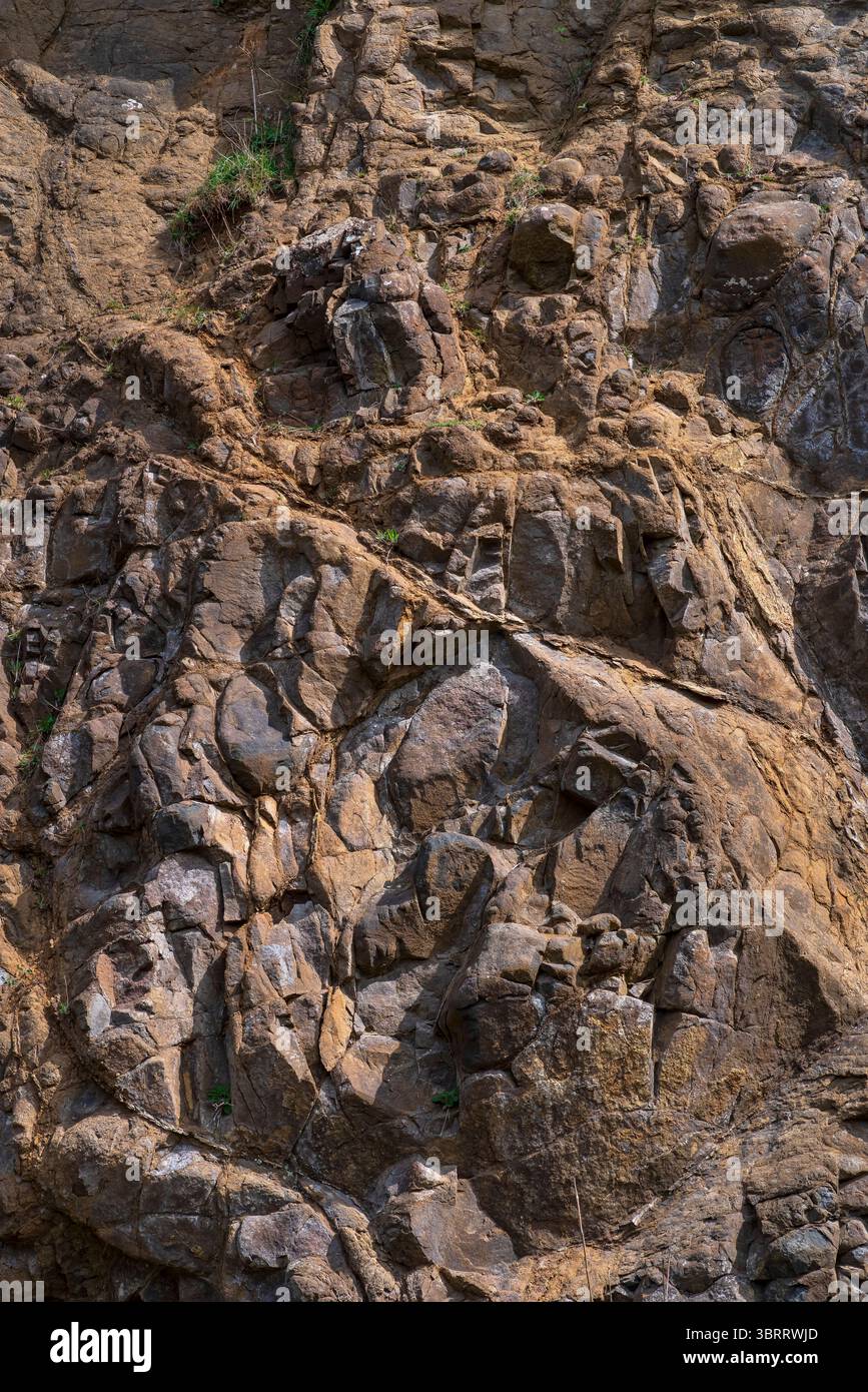 The exposed face of a dolerite (lava) quarry in Tideswell Dale, Peak ...