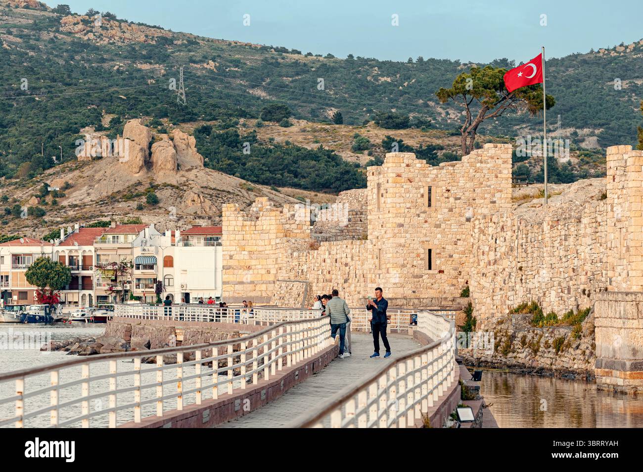 7 May 2025, Foca, Turkiye: Visitors walking along the scenic pathway ...