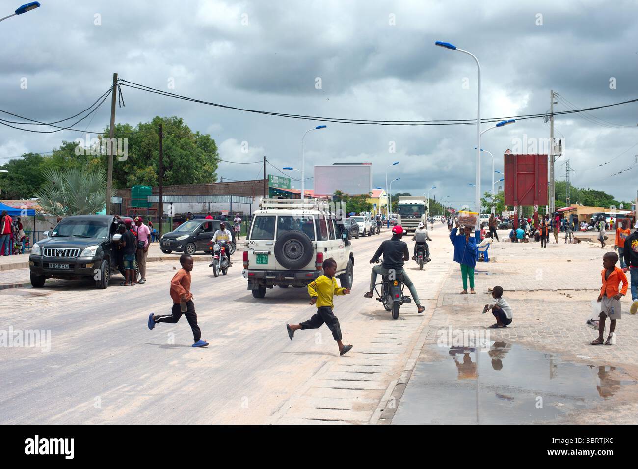 SANTA CLARA, ANGOLA - FEB 13, 2025: Children are running across the ...