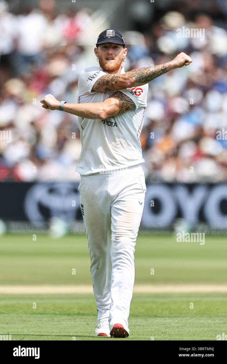 England captain Ben Stokes stretches his arms before bowling another ...