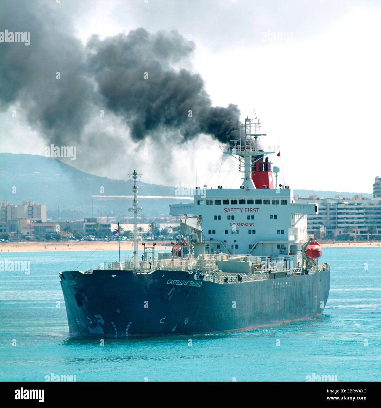 Archival 2006 bow view of cargo ship belching out black smoke soot contaminating emissions from ...
