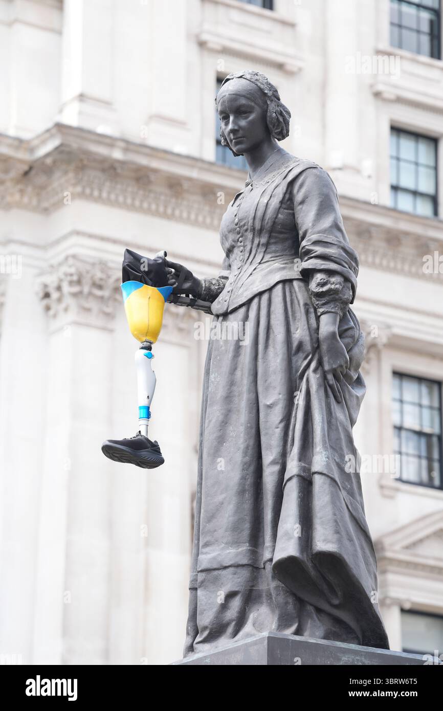 A prosthetic leg in the colours of Ukraine is placed on the statue of ...