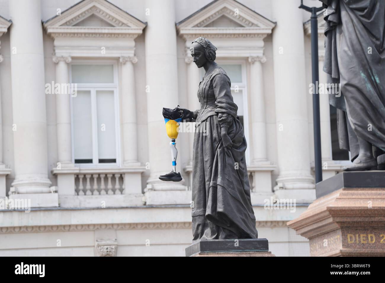 A prosthetic leg in the colours of Ukraine is placed on the statue of ...