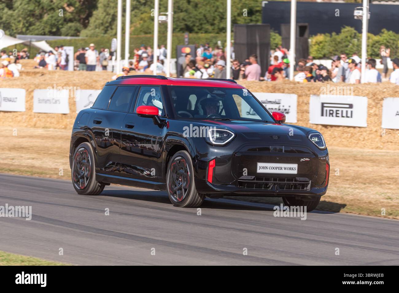 Mini JCW Aceman car driving up the hill climb track at the Goodwood ...