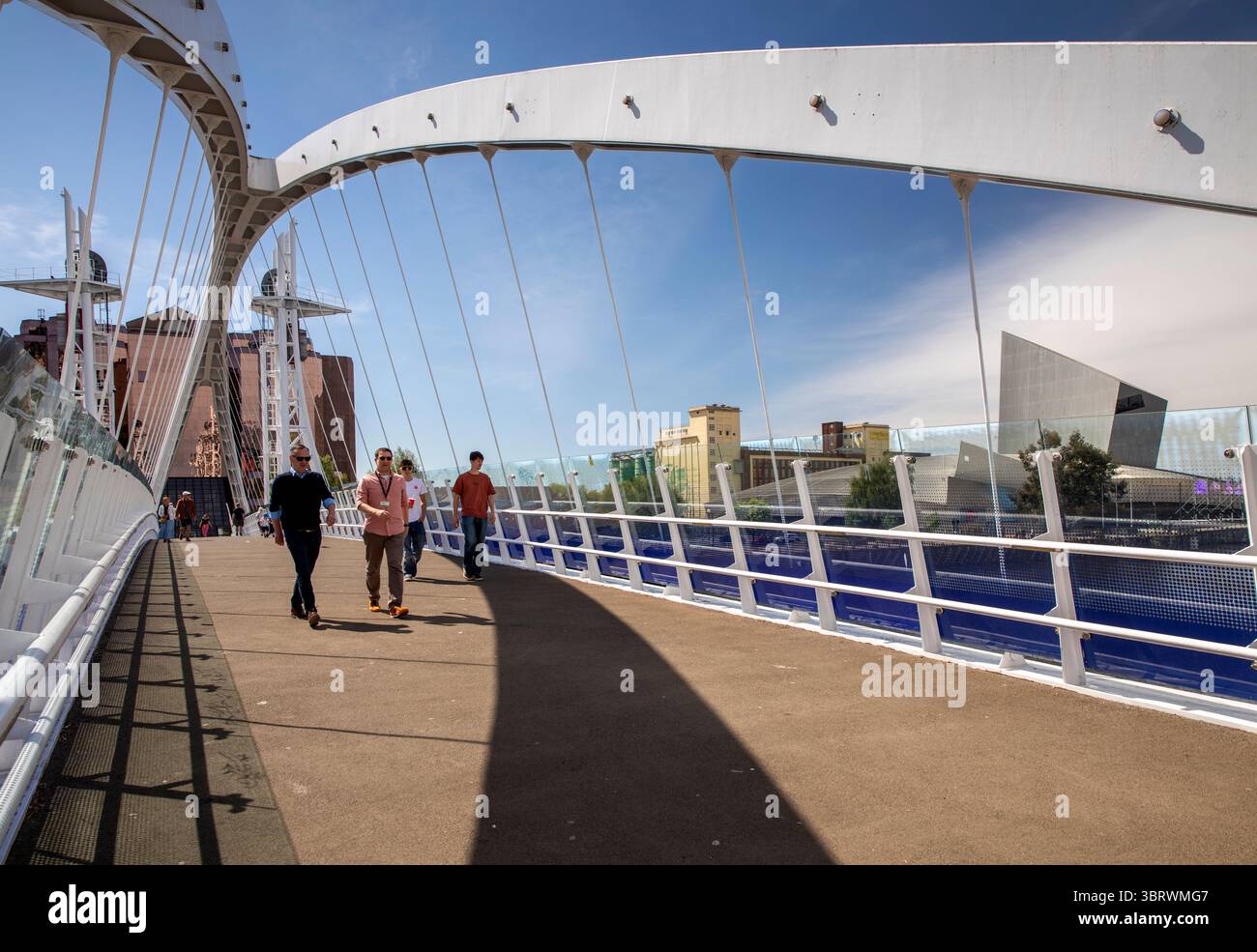 UK, England, Salford, Quays, pedestrians crossing Millennium Bridge to ...