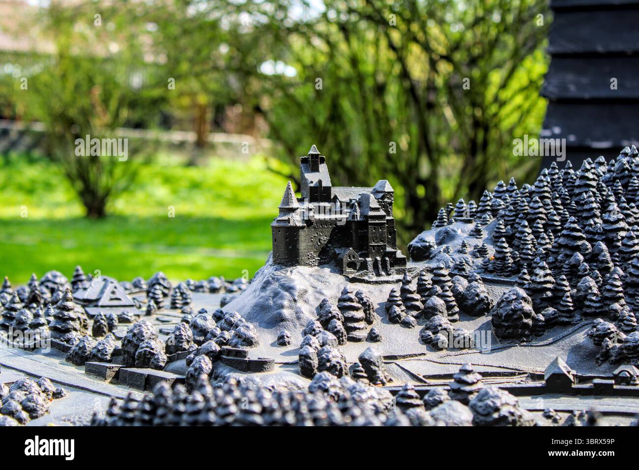 Miniature medieval castle model with pine trees in outdoor model ...