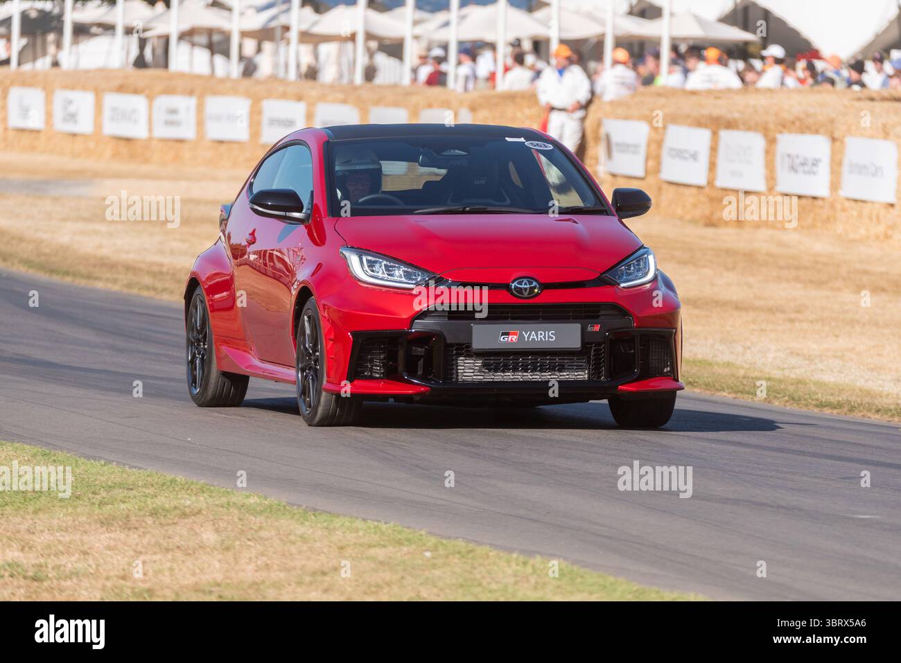 Toyota GR Yaris car driving up the hill climb track at the Goodwood ...
