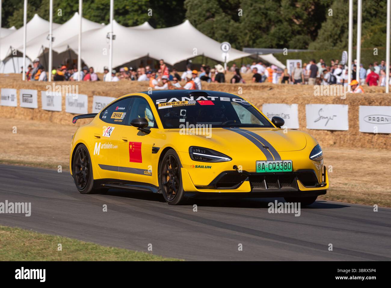 Xiaomi SU7 Ultra car driving up the hill climb track at the Goodwood ...