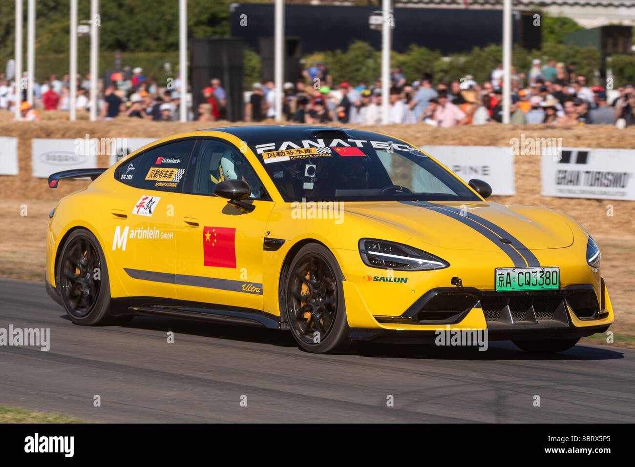 Xiaomi SU7 Ultra car driving up the hill climb track at the Goodwood ...