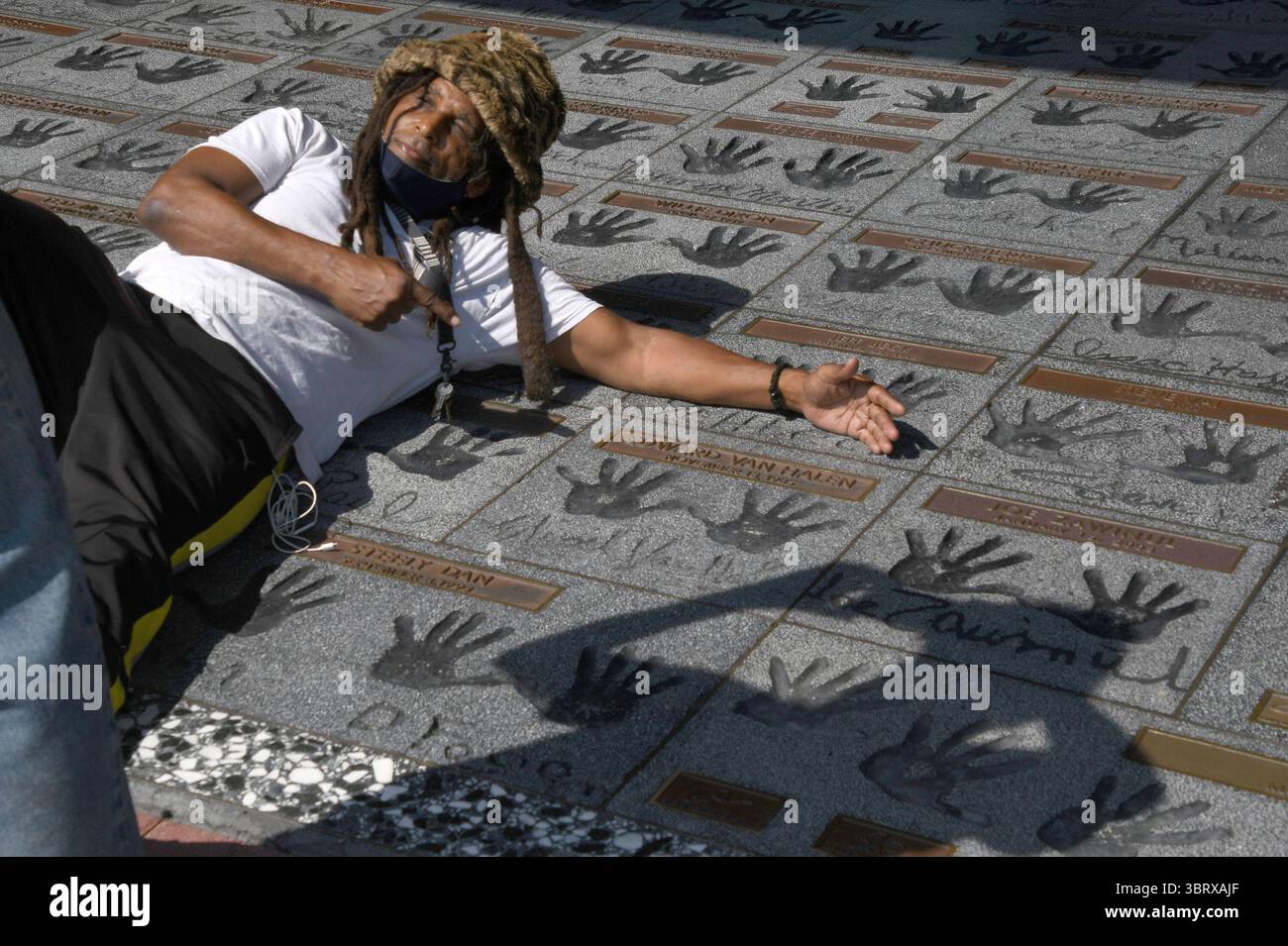 Eddie Van Halen fan Marlon Jones poses with the hand prints of EddieVan ...