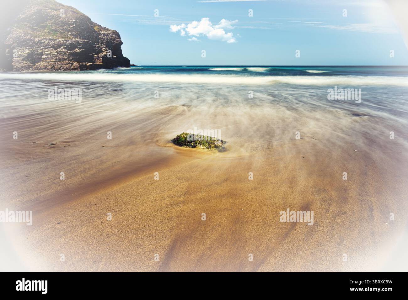 A long exposure photograph captures the ethereal flow of waves washing ...