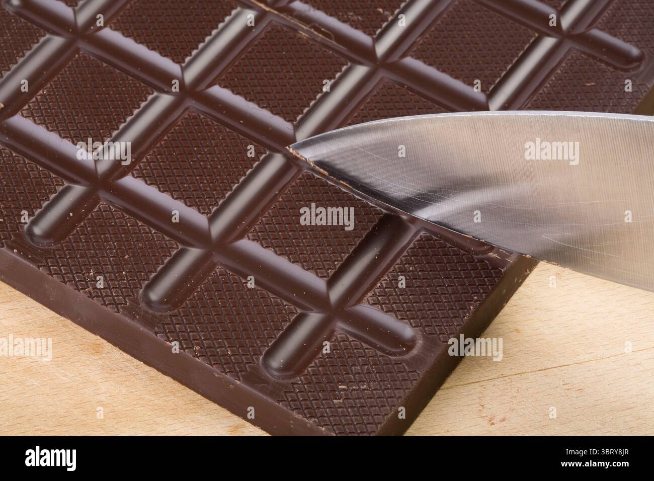 Cutting chocolate bar Stock Photo - Alamy