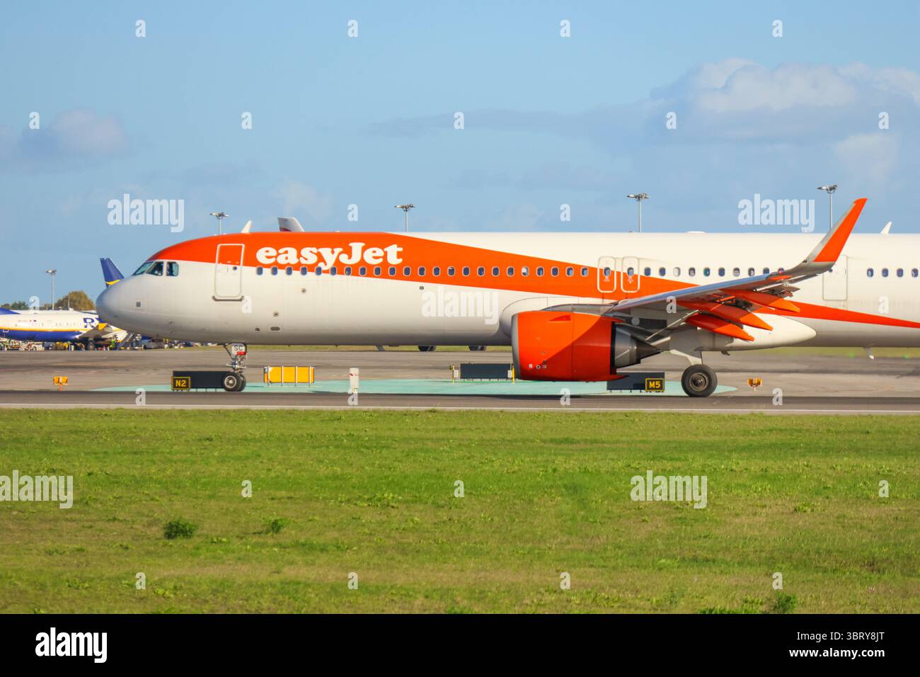 Orange and white easyjet airbus a320 taxiing at lisbon humberto delgado ...
