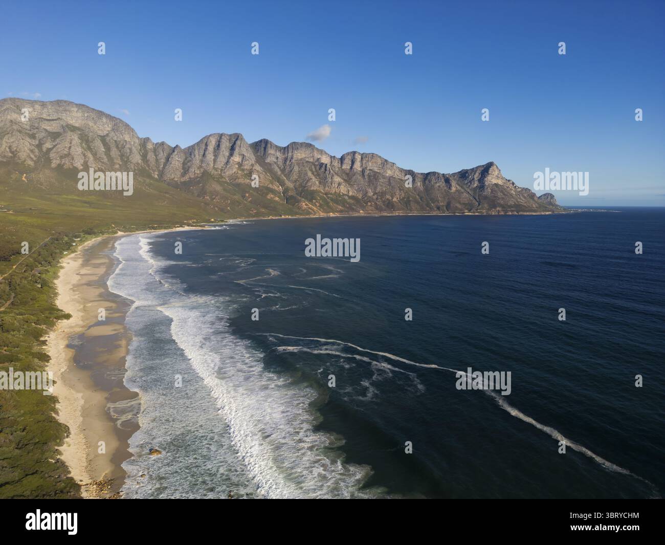 Aerial view of where the sandy beach meets the blue ocean under the ...