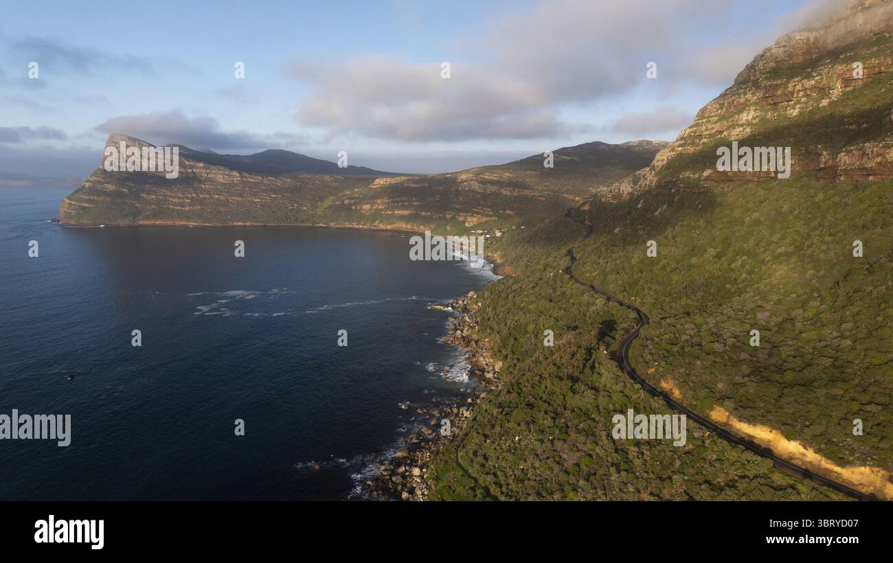 Aerial view of where the winding coastal road meets the rugged ...