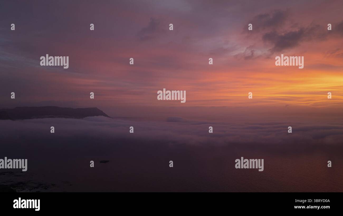 Aerial view of Table Mountain shrouded in ethereal mist beneath a ...