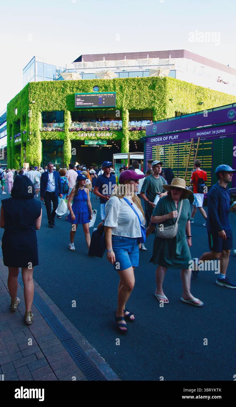 People walking outside Centre Court passing the Order of Play notice ...