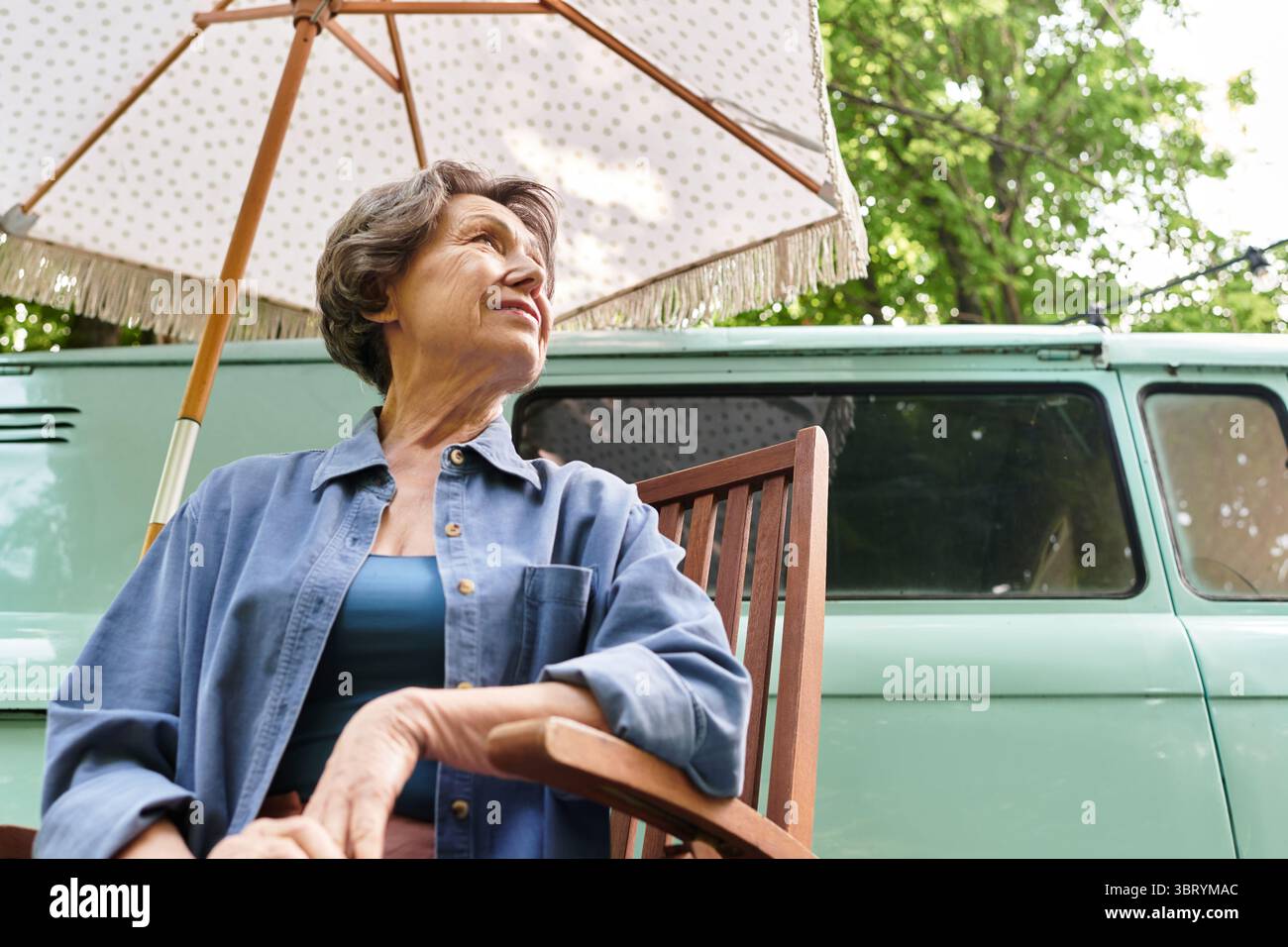 A radiant senior woman relaxes in a garden setting, appreciating the ...