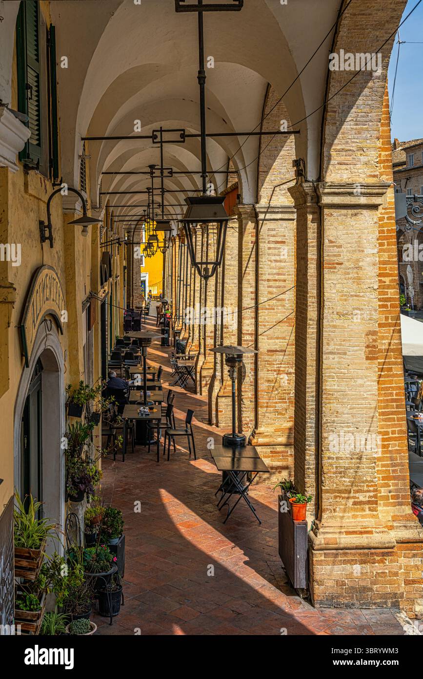 The tall portico with brick pillars along the main street of Fermo ...