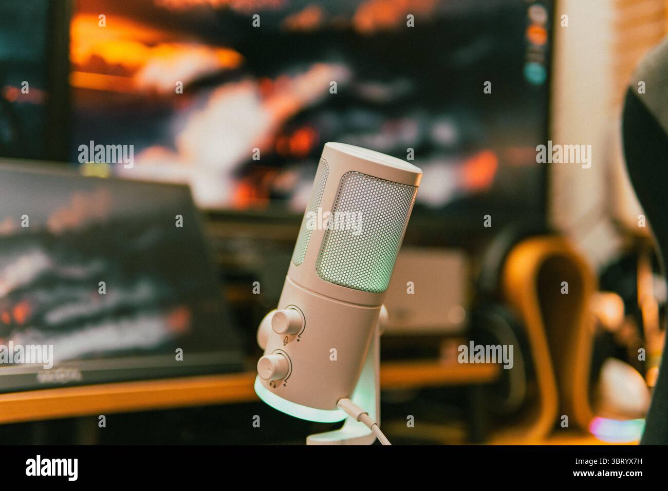 Modern cinematic desk setup with triple monitor, gaming chair, ambient light, and cozy ...