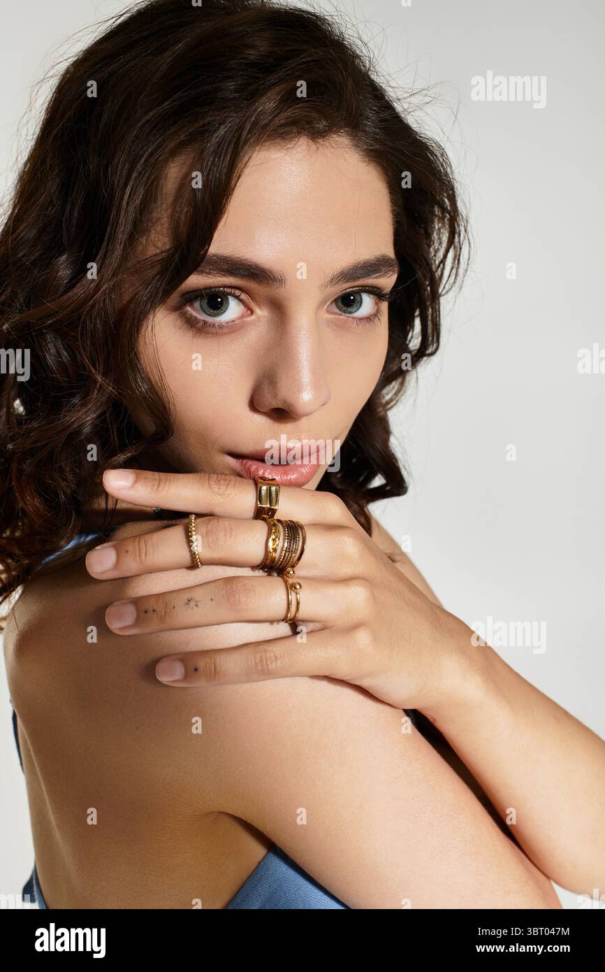A young woman with beautiful makeup poses gracefully, highlighting her ...