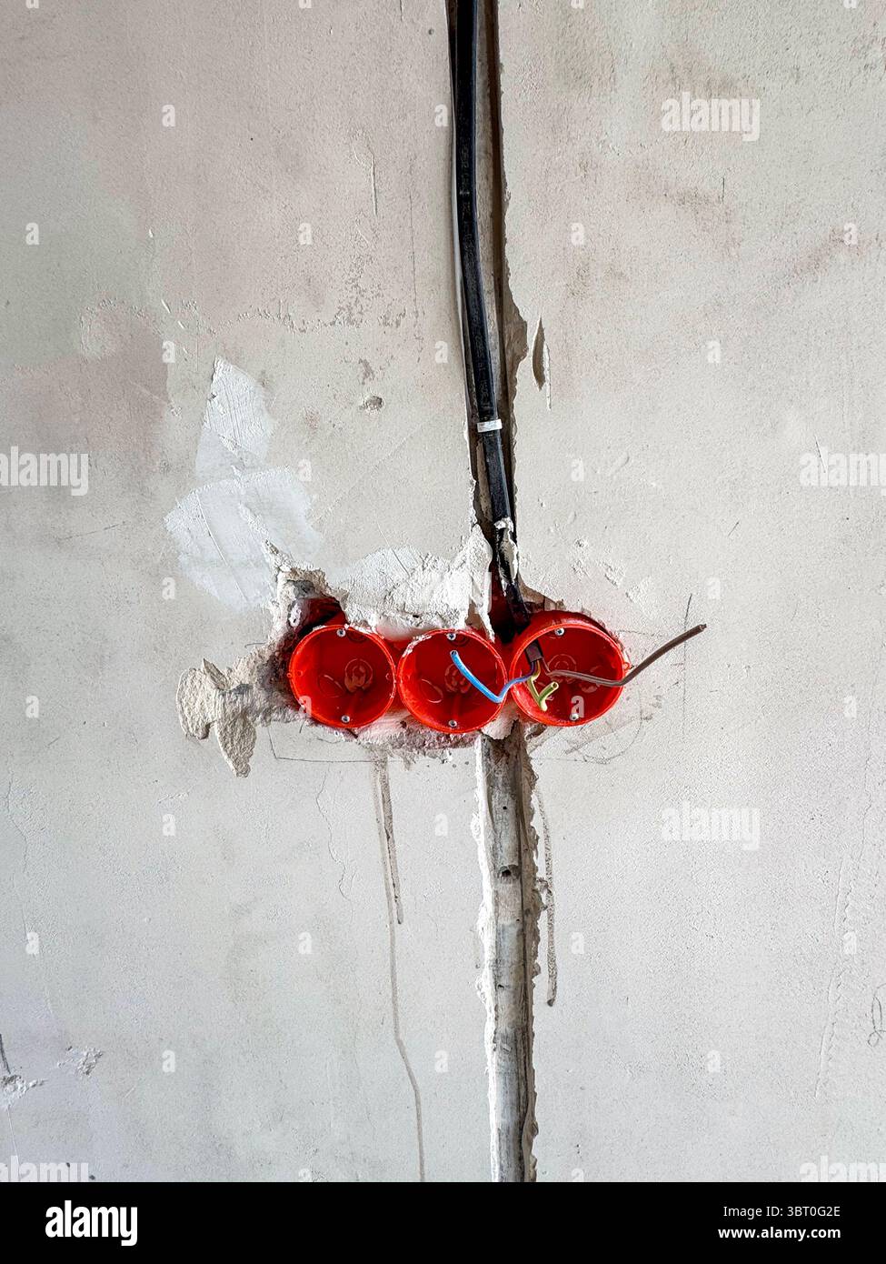 Wall-mounted wire setup for future outlets in a concrete wall. Concept ...