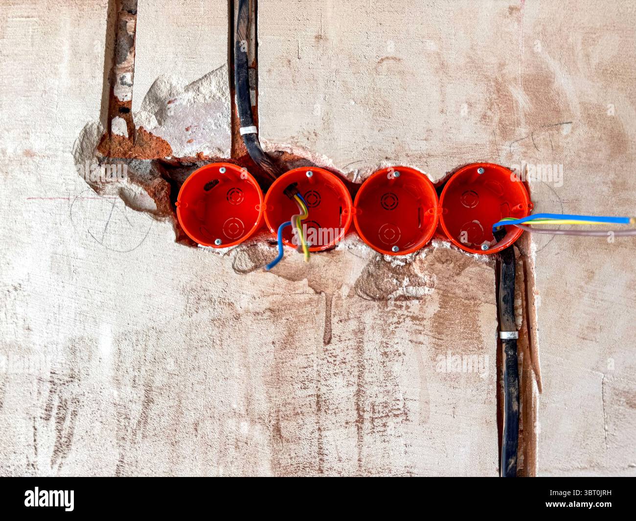 Exposed wiring and unfinished sockets during renovation process ...