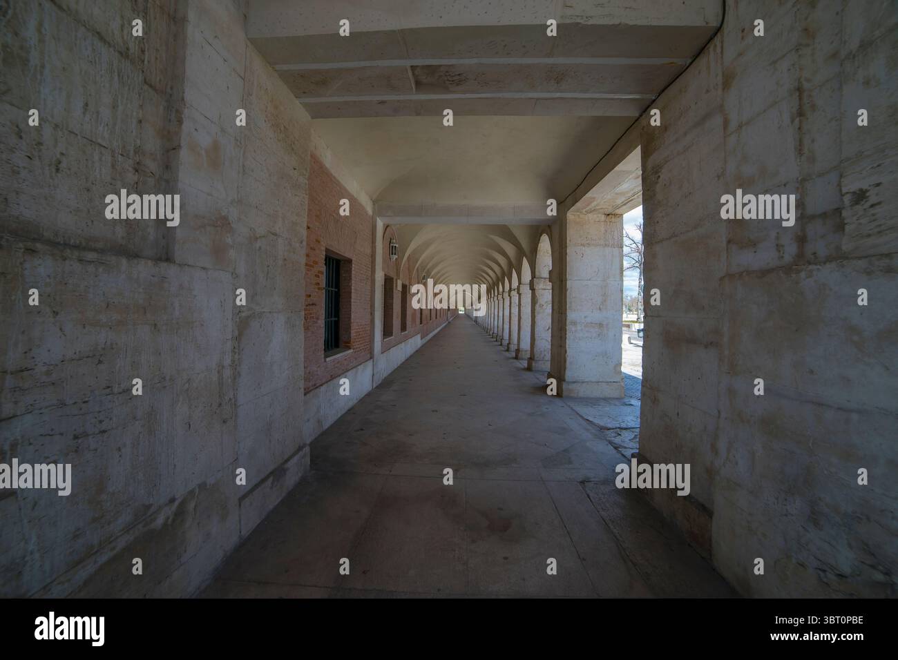 Walk through the elegant passage with old arches in Aranjuez, Spain ...