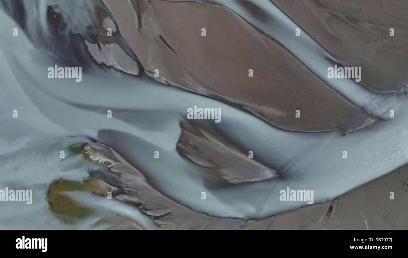 Aerial view of glacial river carving paths through the landscape ...