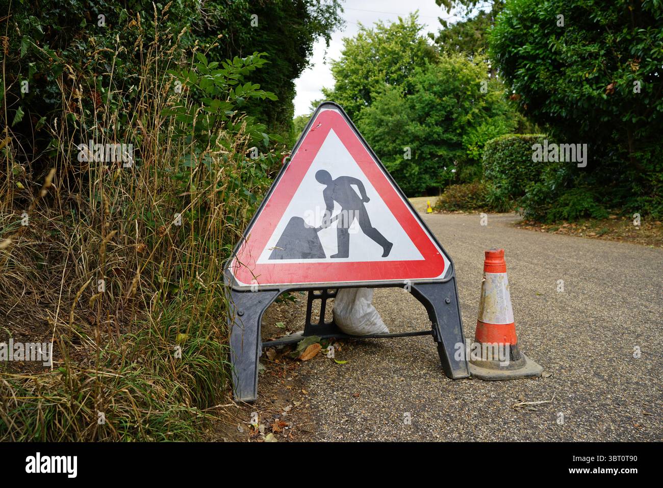 Triangular Roadwork Warning Sign Along a Suburban Pathway Surrounded by ...
