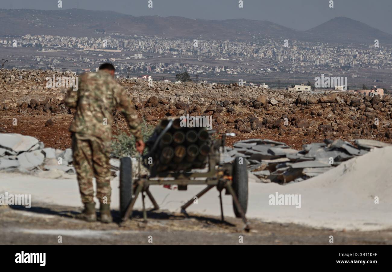 A Syrian government soldier sets a rocket launcher at the edge of ...
