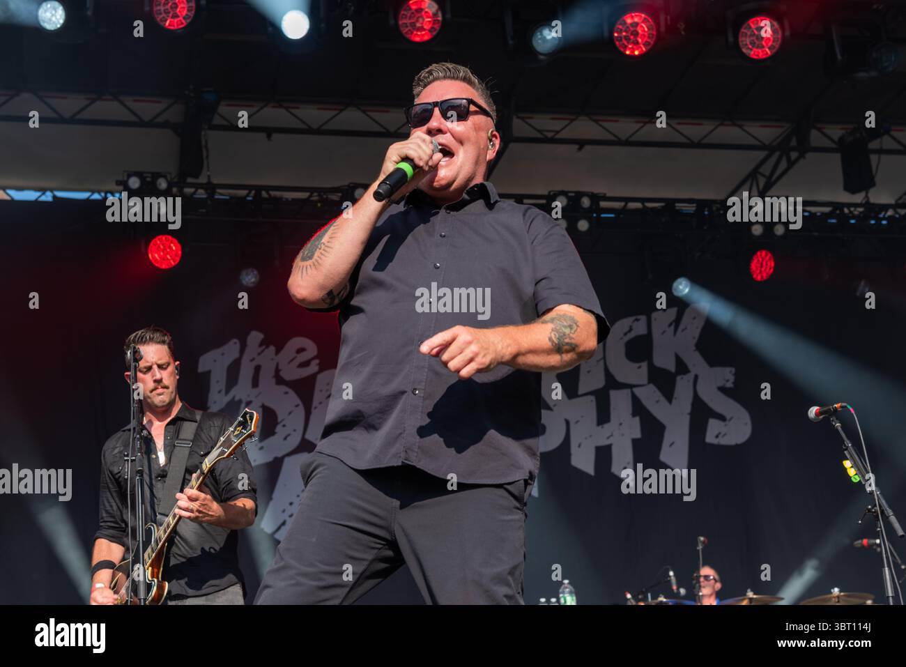 Dropkick Murphys’ guitarist Tim Brennan plays behind lead singer, Ken ...