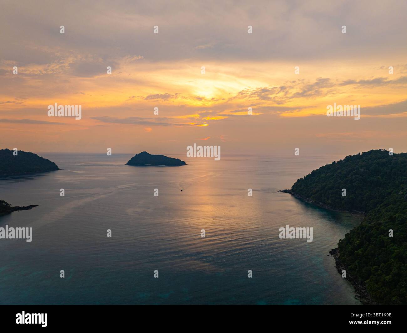 Aerial view of The sun sets at Ao Mai Ngam, Surin Islands. The ...