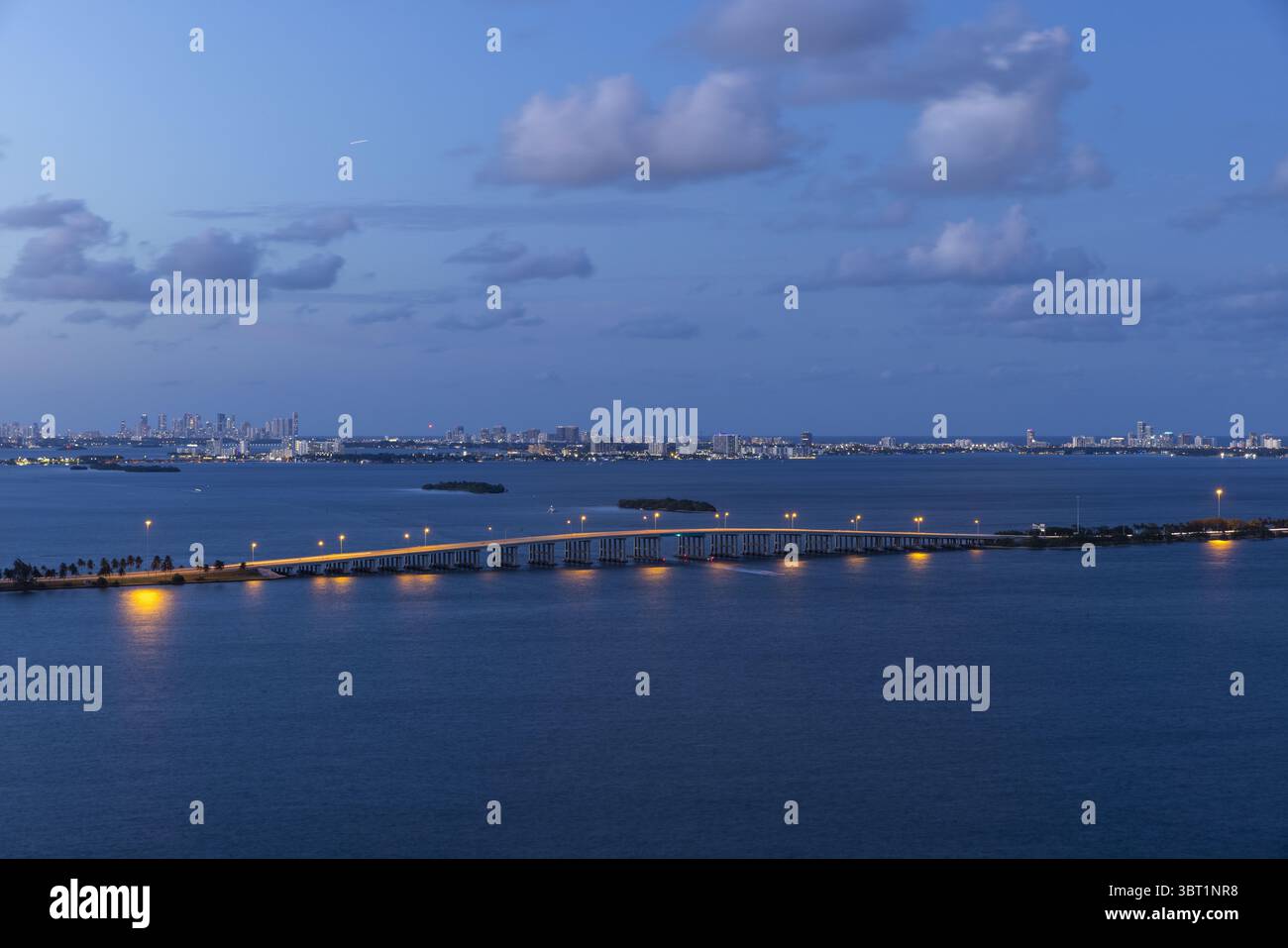 Aerial view of a bridge stretches across the bay under the fading ...