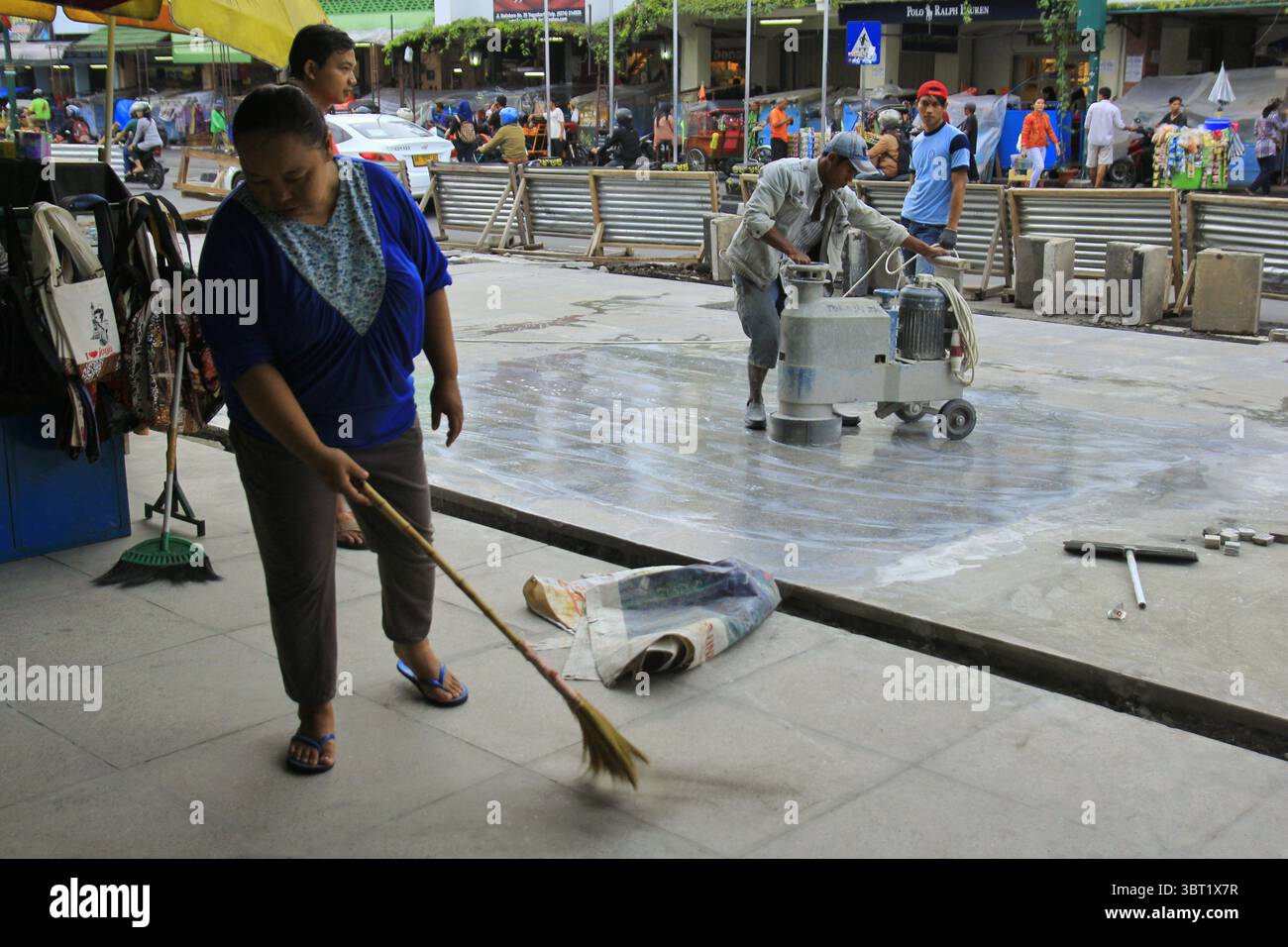 Workers complete public facilities work on sidewalks for pedestrians ...