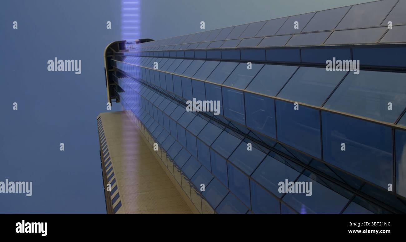 Shining glass skyscraper rising at street-level city view, with ...