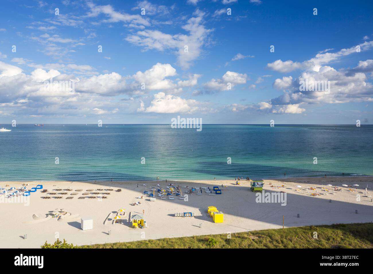 Aerial view of sun-kissed sands meet the turquoise sea, dotted with ...