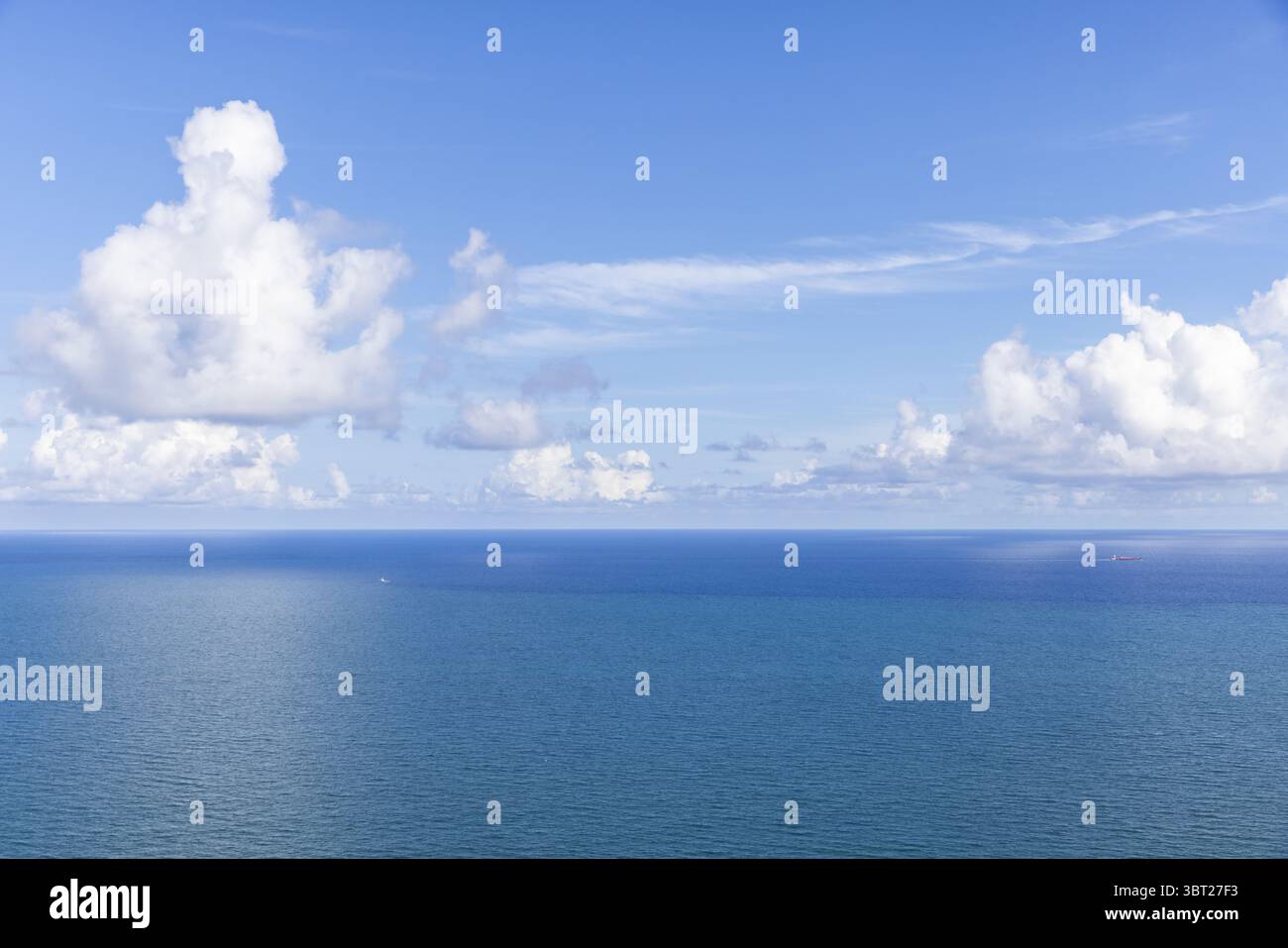 Aerial view of a vast expanse of deep blue ocean meeting the horizon ...