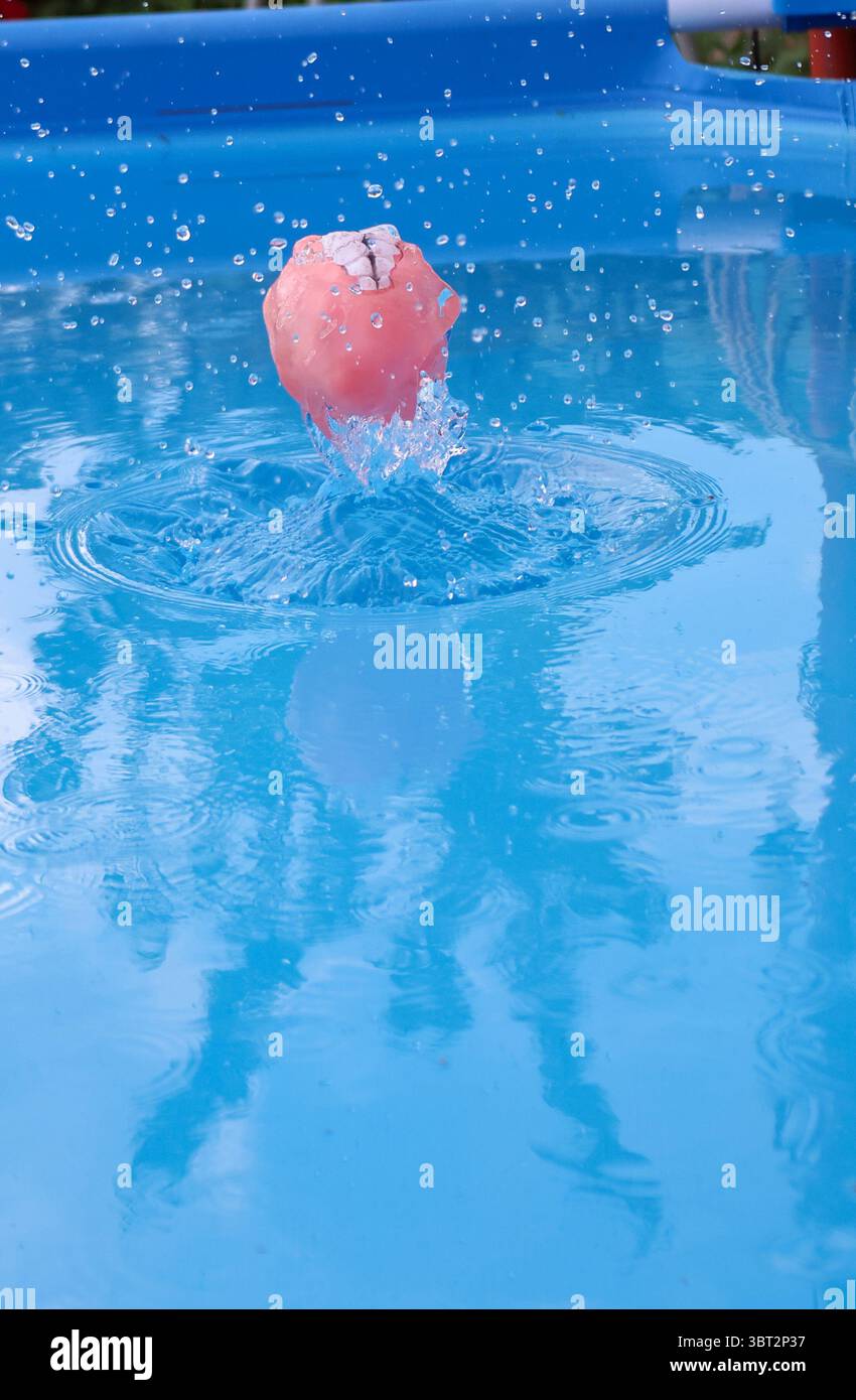 ball falling into the pool Stock Photo - Alamy