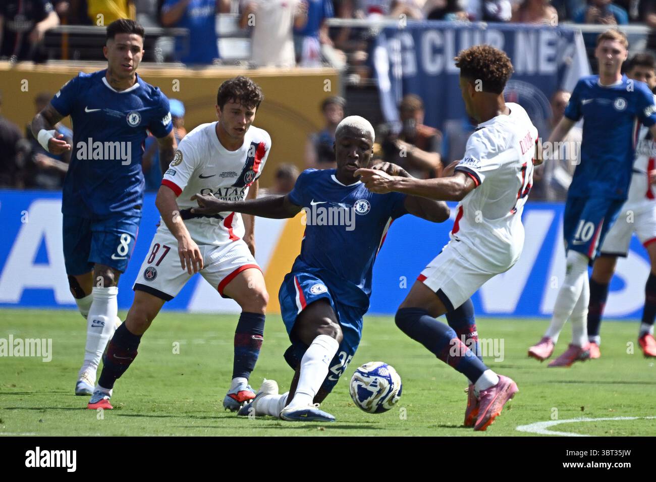Moisés Caicedo #25 of Chelsea FC controls the ball between Joao Neves ...
