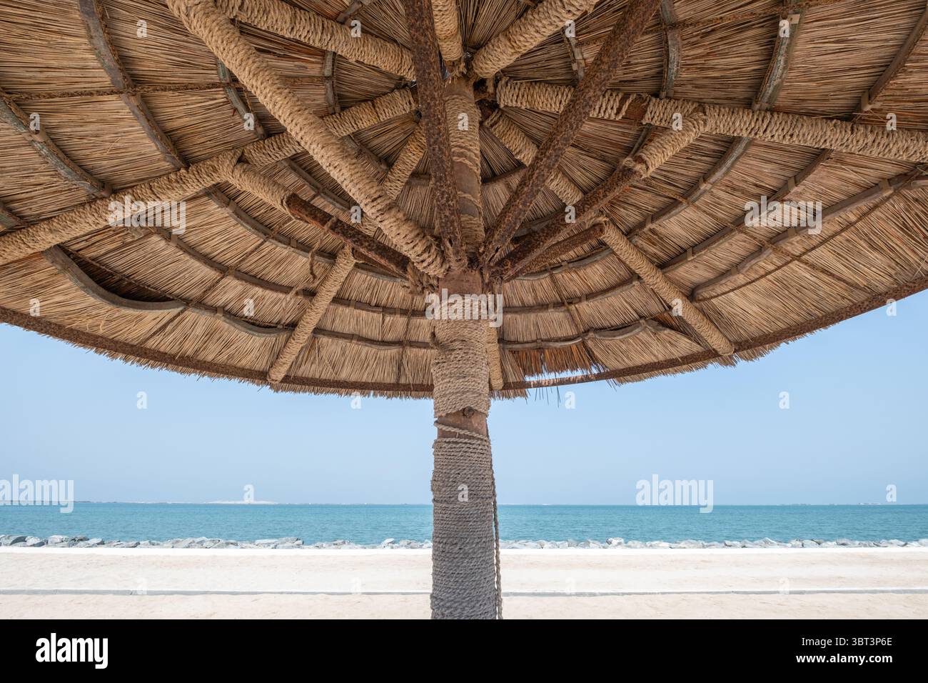 beach retreat thatched beach umbrella close up view, clear blue ocean ...