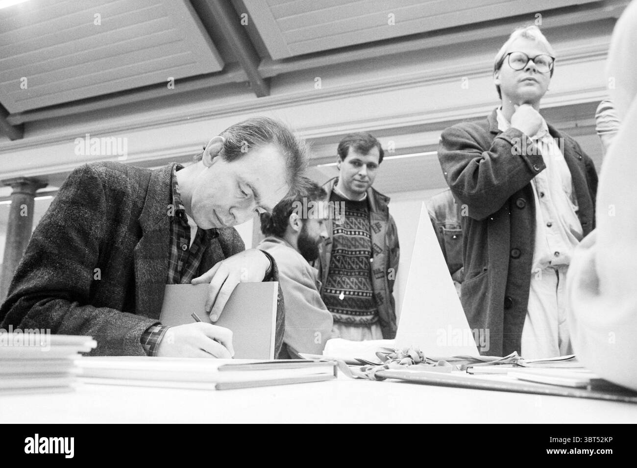 Hunched over desk writing hi-res stock photography and images - Alamy