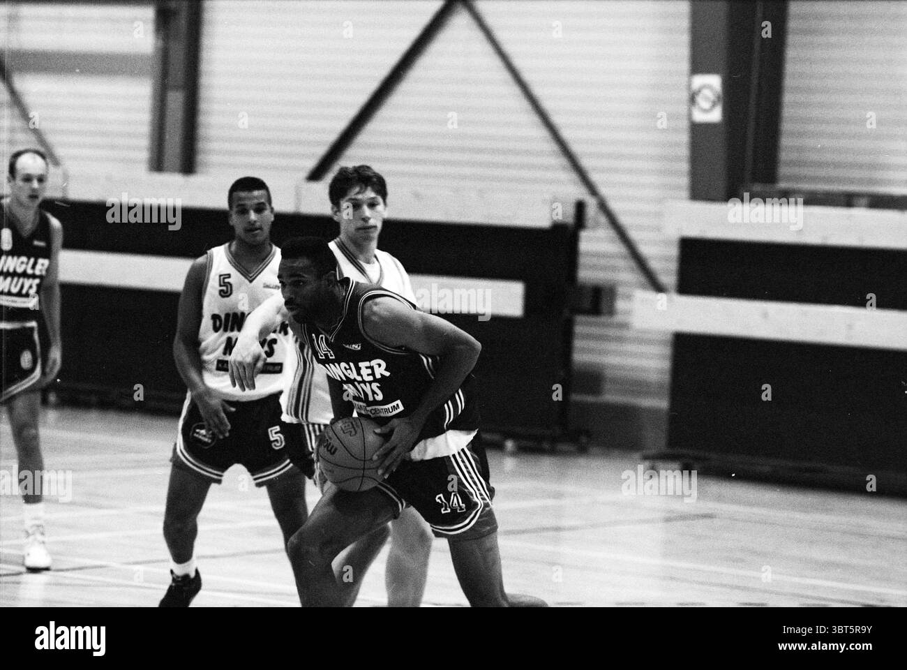 Three basketball players leaning in hi-res stock photography and images ...