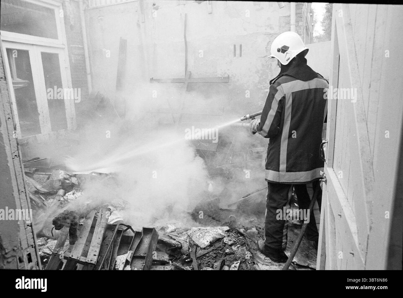 Fire brigade extinguishes fire in pile of rubbish behind house, Whizgle ...