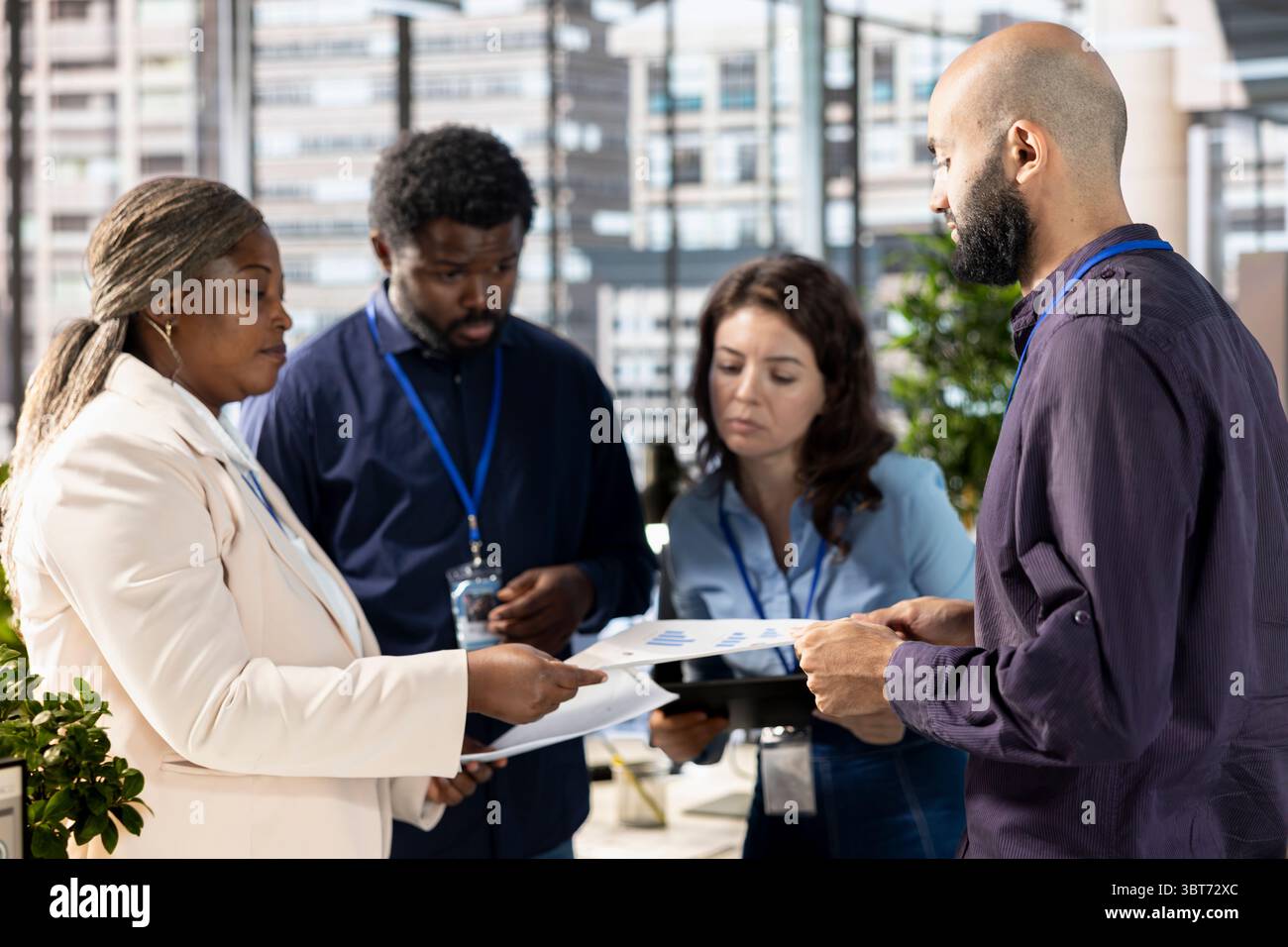 Multiethnic executive team meeting to discuss and look over ...
