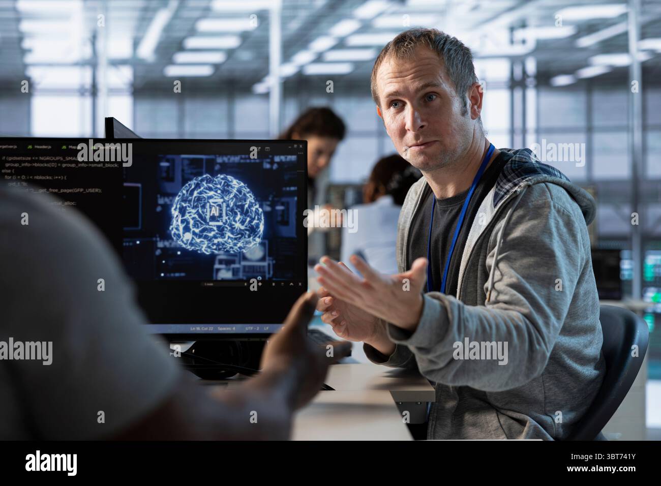 Team work discussing technical issues hi-res stock photography and ...