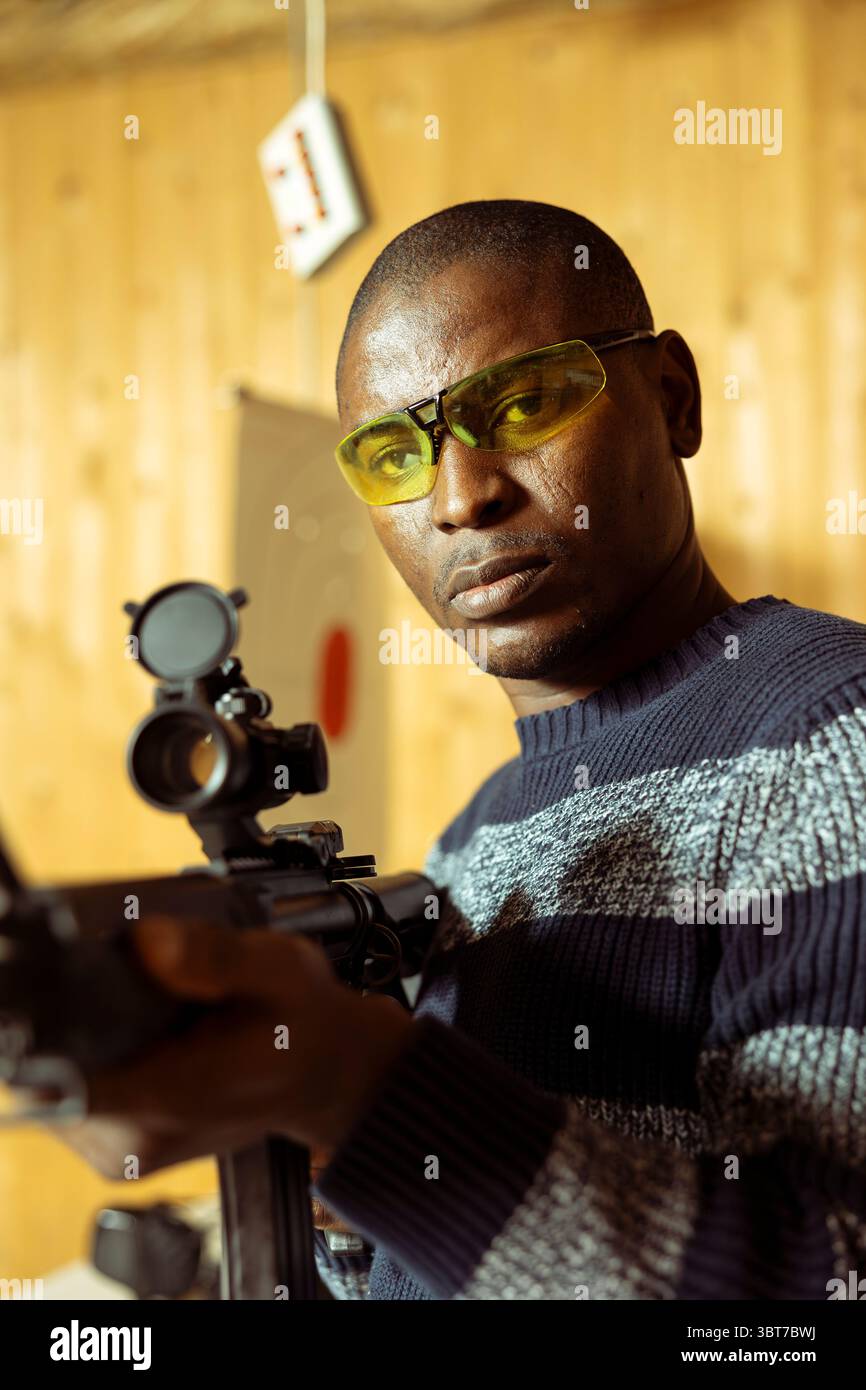 Portrait of person doing training, learning proper rifle holding ...